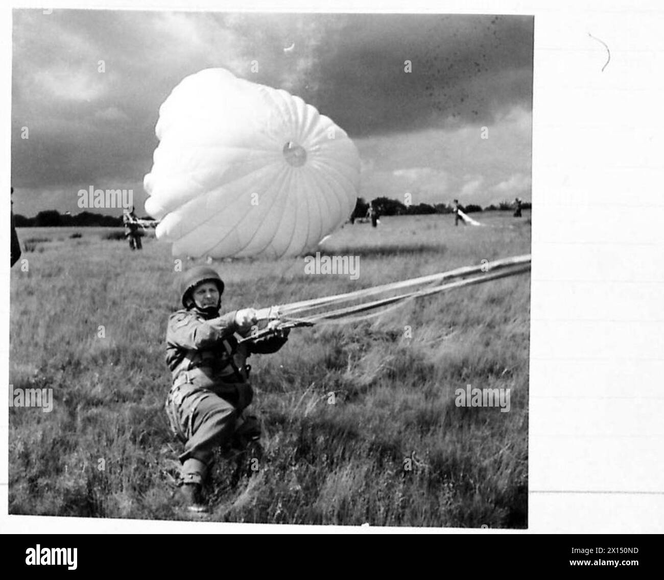 PARATROOPS IN TRAINING - Paratroops controlling their 'chutes after a ...