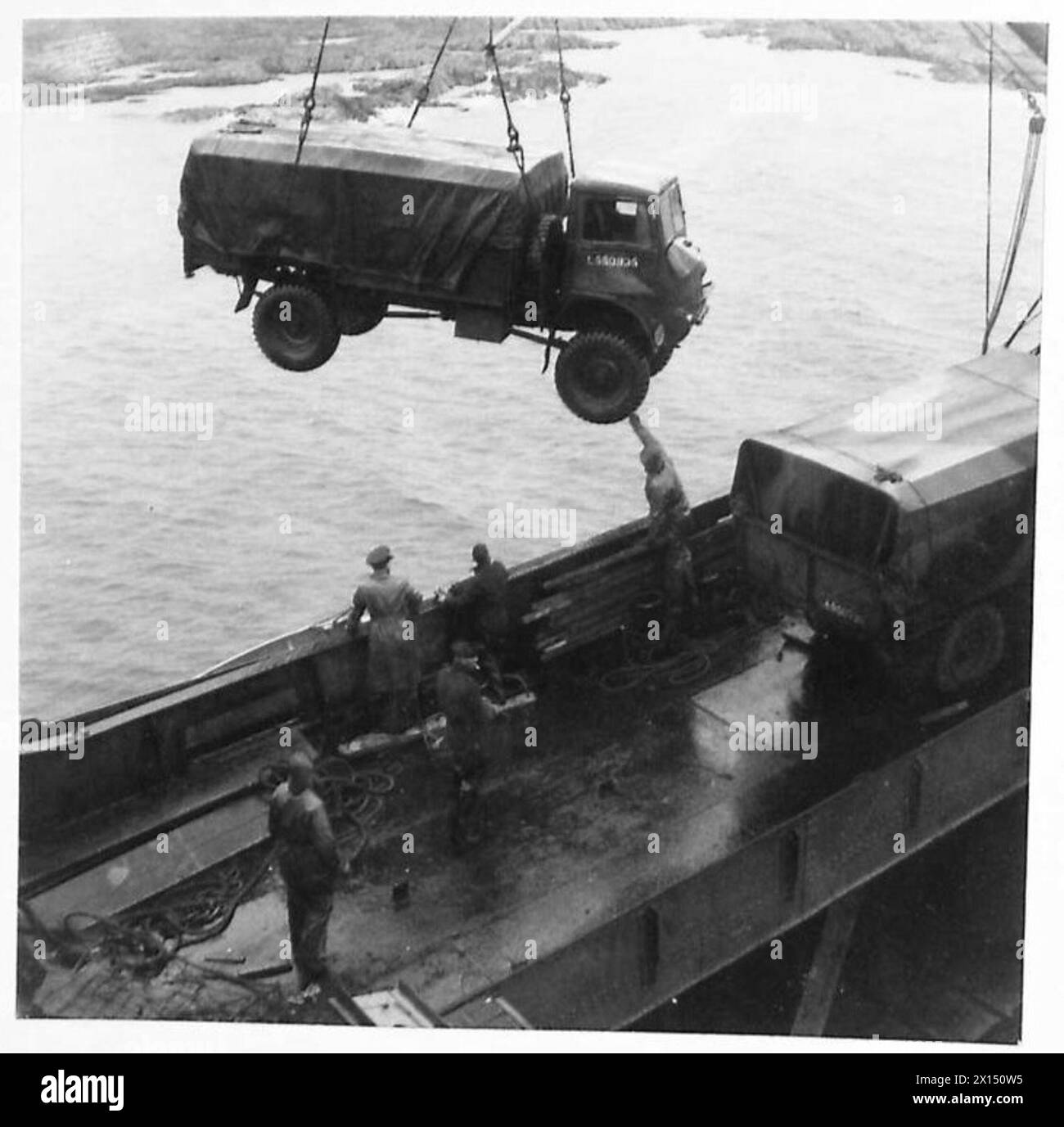 TAKING OFF LORRIES FROM GROUNDED SHIP - Army lorry being hoisted from ...