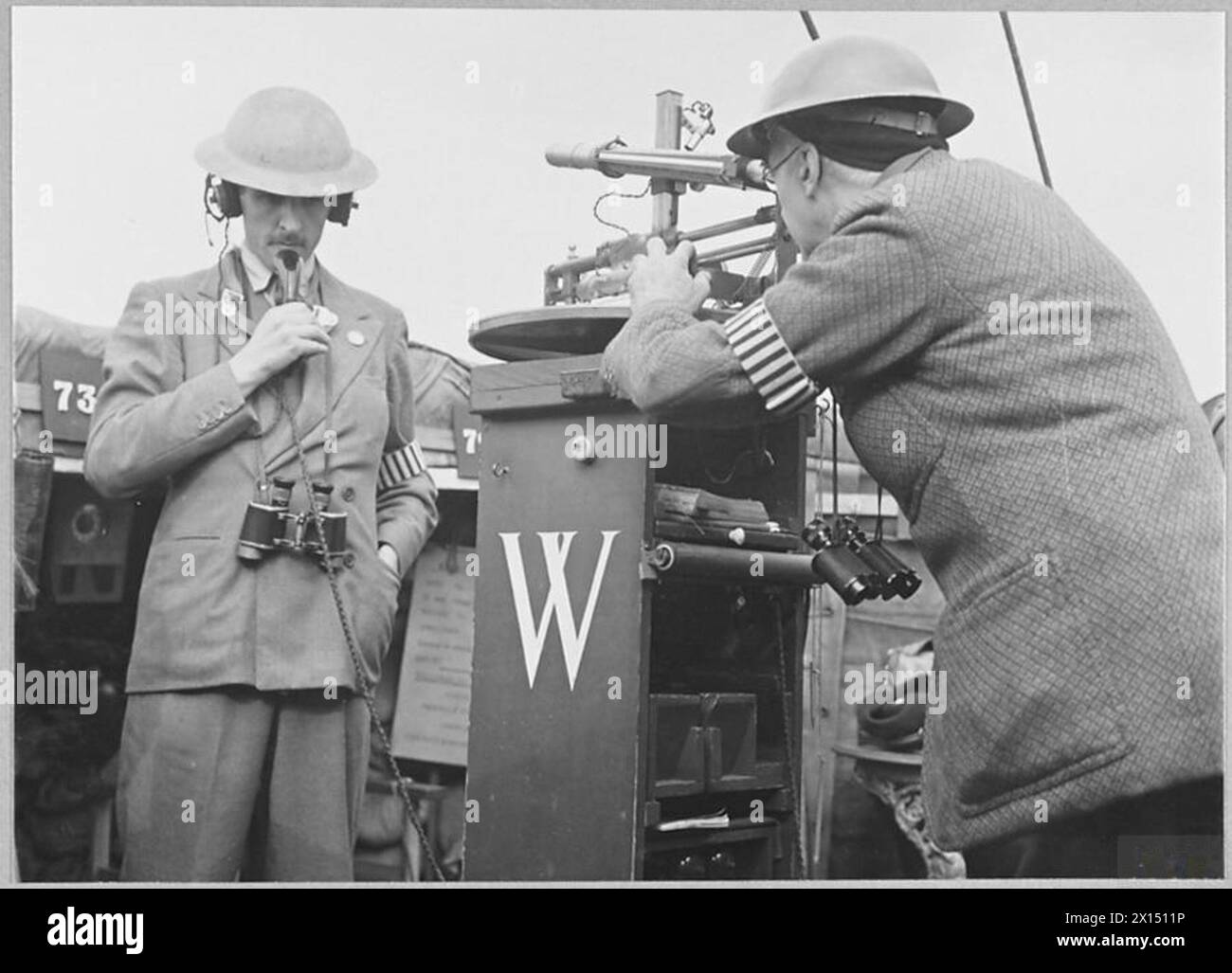 OBSERVER CORPS POST ON HIGH BUILDING - No.1 Observer operates the ...