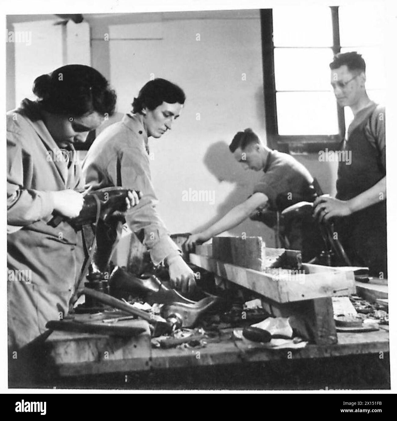negative - ATS cobblers at work. Pte. Millicent War (the taller of the ...