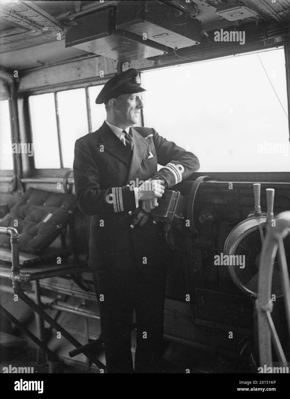 Lieutenant Commander W.L. Puxley commanding HMS Montgomery, an ex-US ...