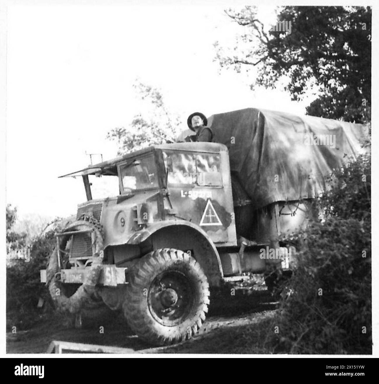 A Bren gunner aboard a troop carrier maintains watch for enemy aircraft ...
