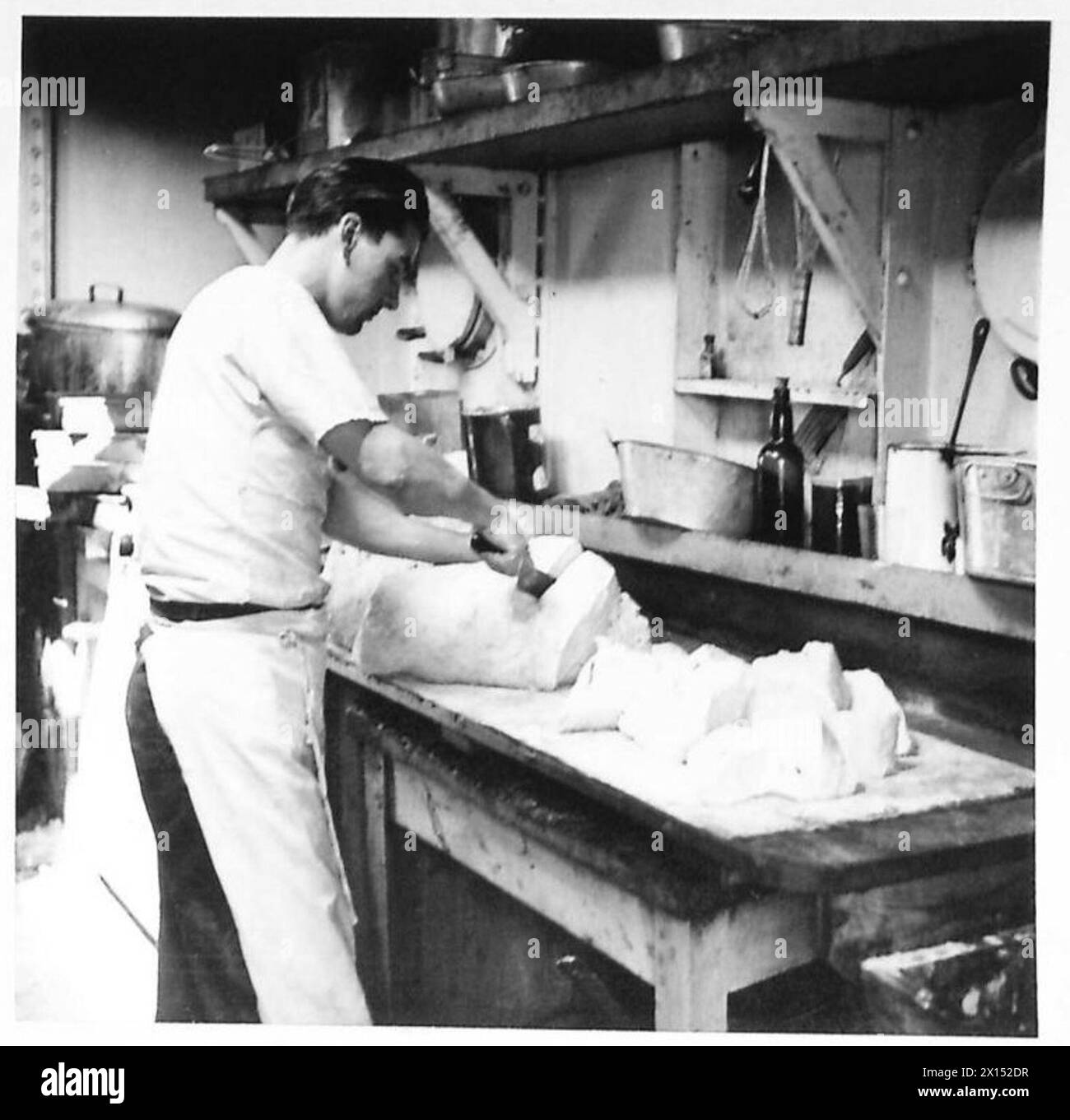 ON BOARD AN AFRICAN BOUND SHIP IN CONVOY - The ship's cook bakes bread ...
