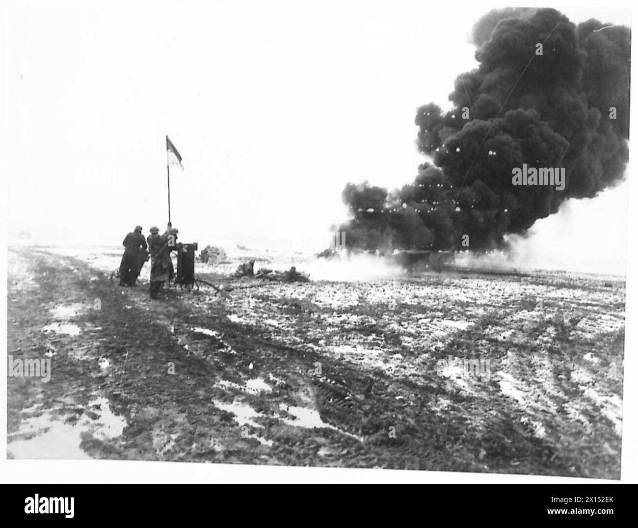 Factory workers observe the British Army using a 'Harvey' flamethrower ...