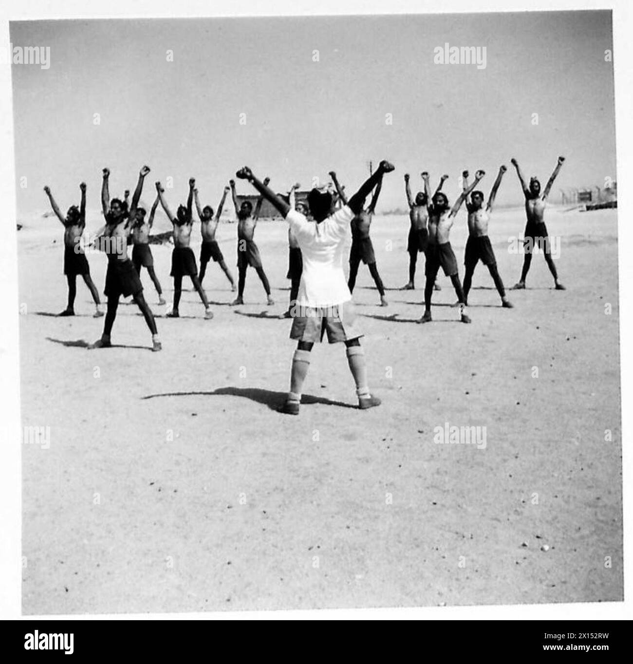 An Indian physical training instructor conducts a class, demonstrating ...