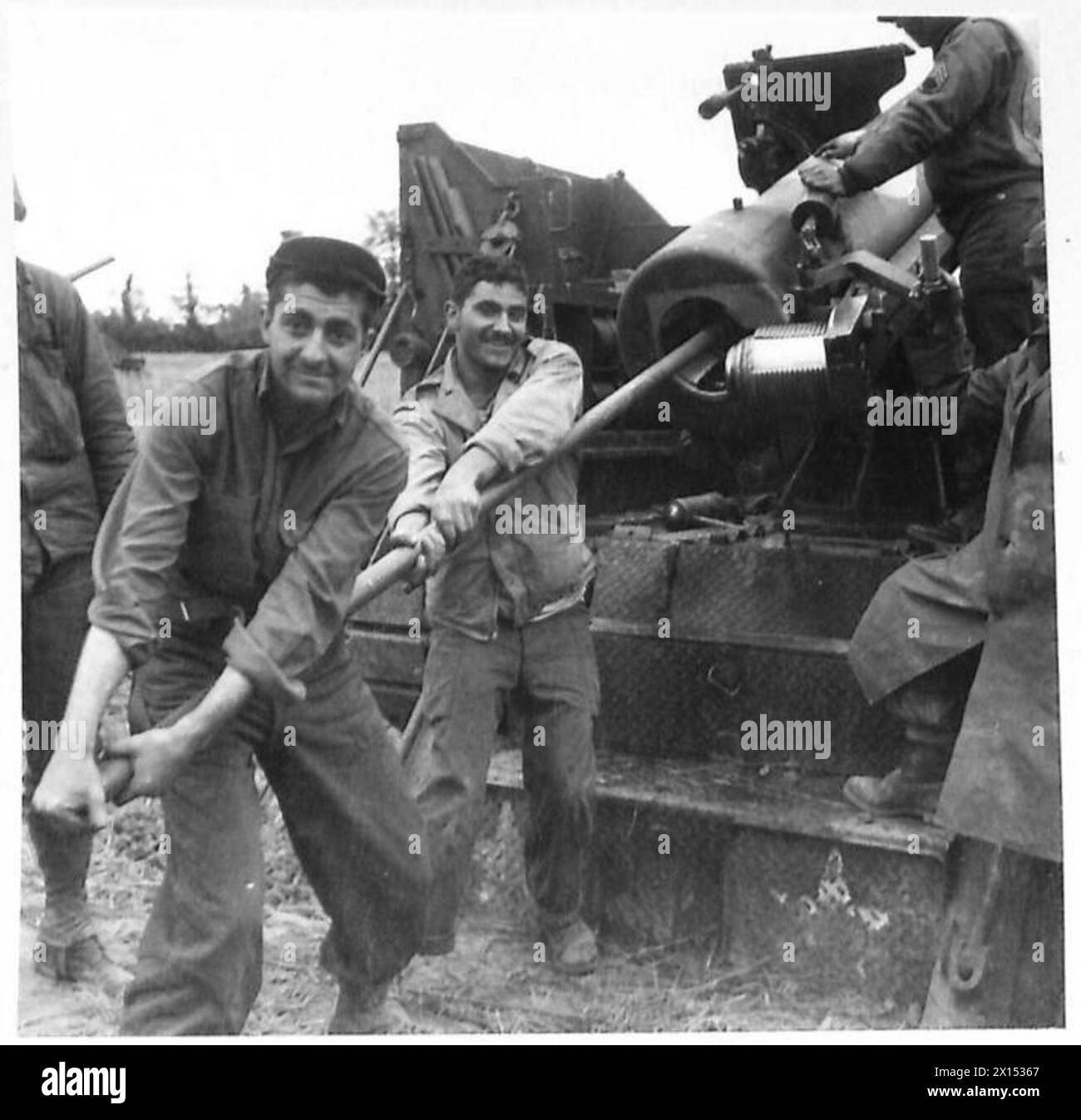 THE CAMPAIGN IN NORMANDY 1944 - The crew ramming a shell into the breech of an M12 GMC 155mm ...
