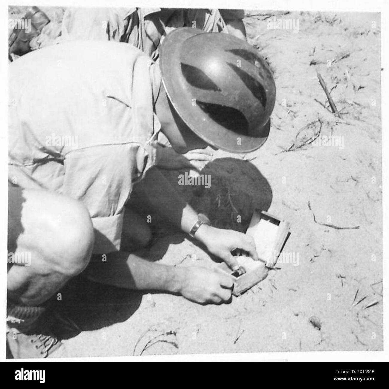 British Army personnel in Italy in 1944 render a small wooden-cased ...