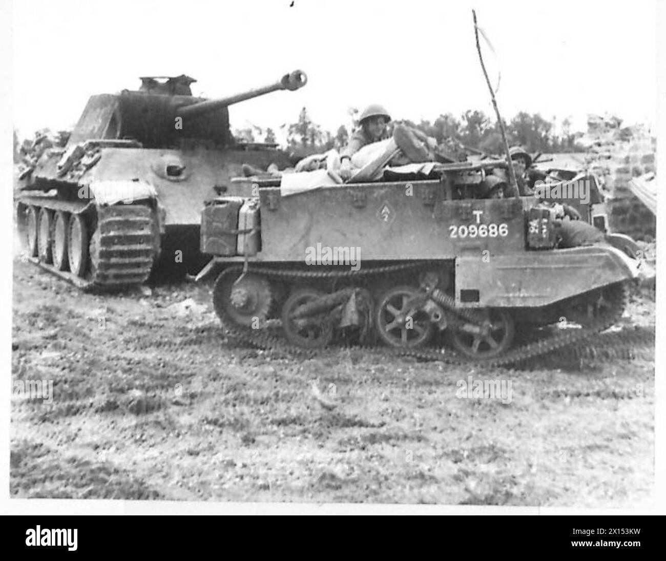 A British Bren carrier evacuates wounded soldiers past a destroyed ...