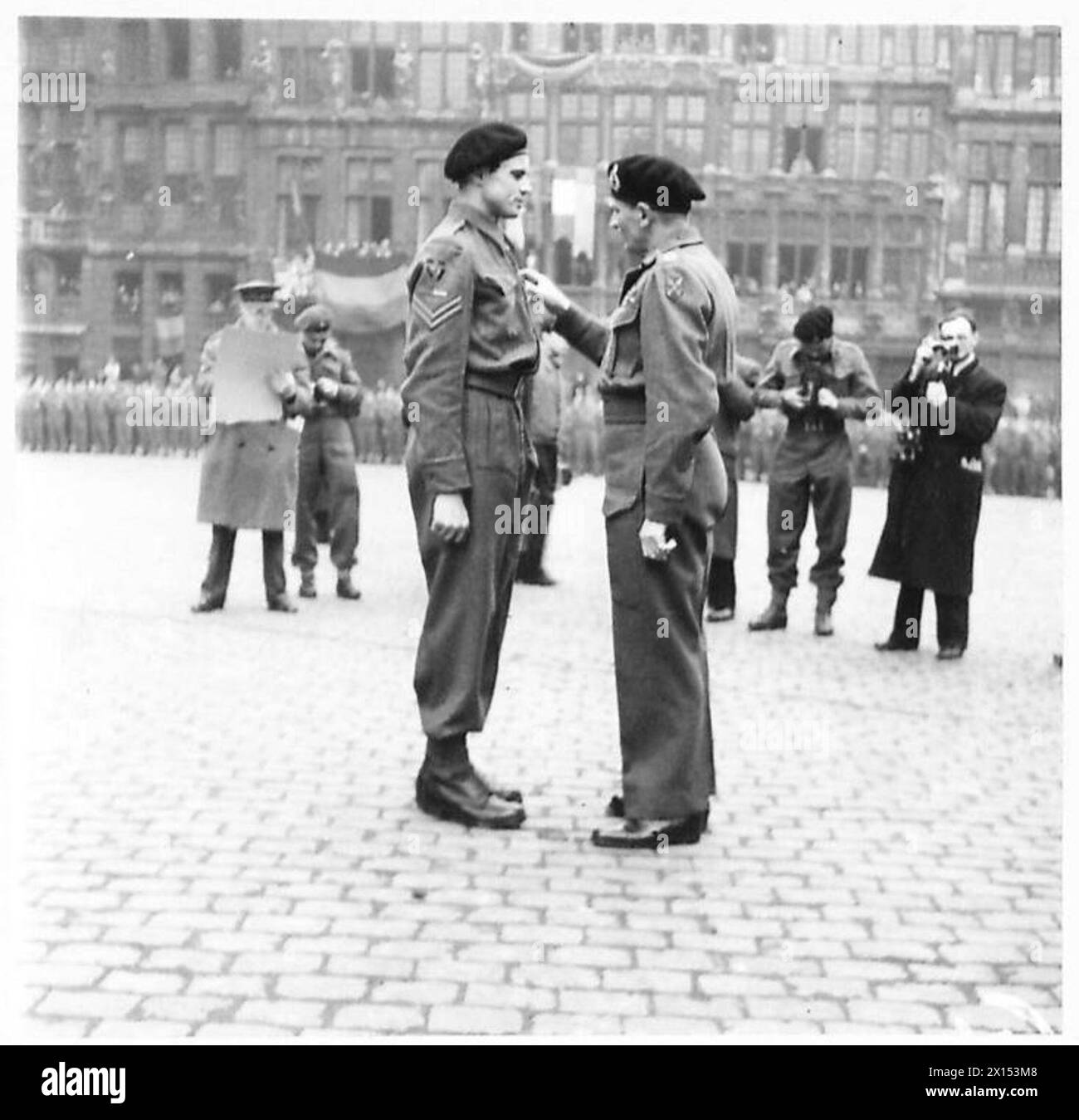 Corporal C. Jouniax receives the Military Medal during an investiture ...