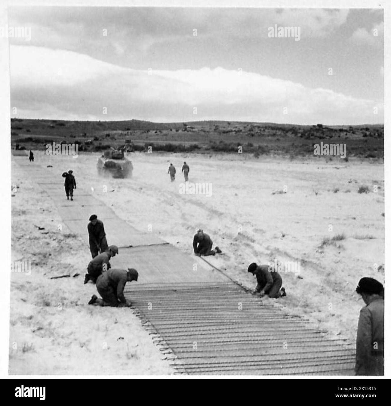 Royal Engineers of the First Army lay matting and wire netting over a ...
