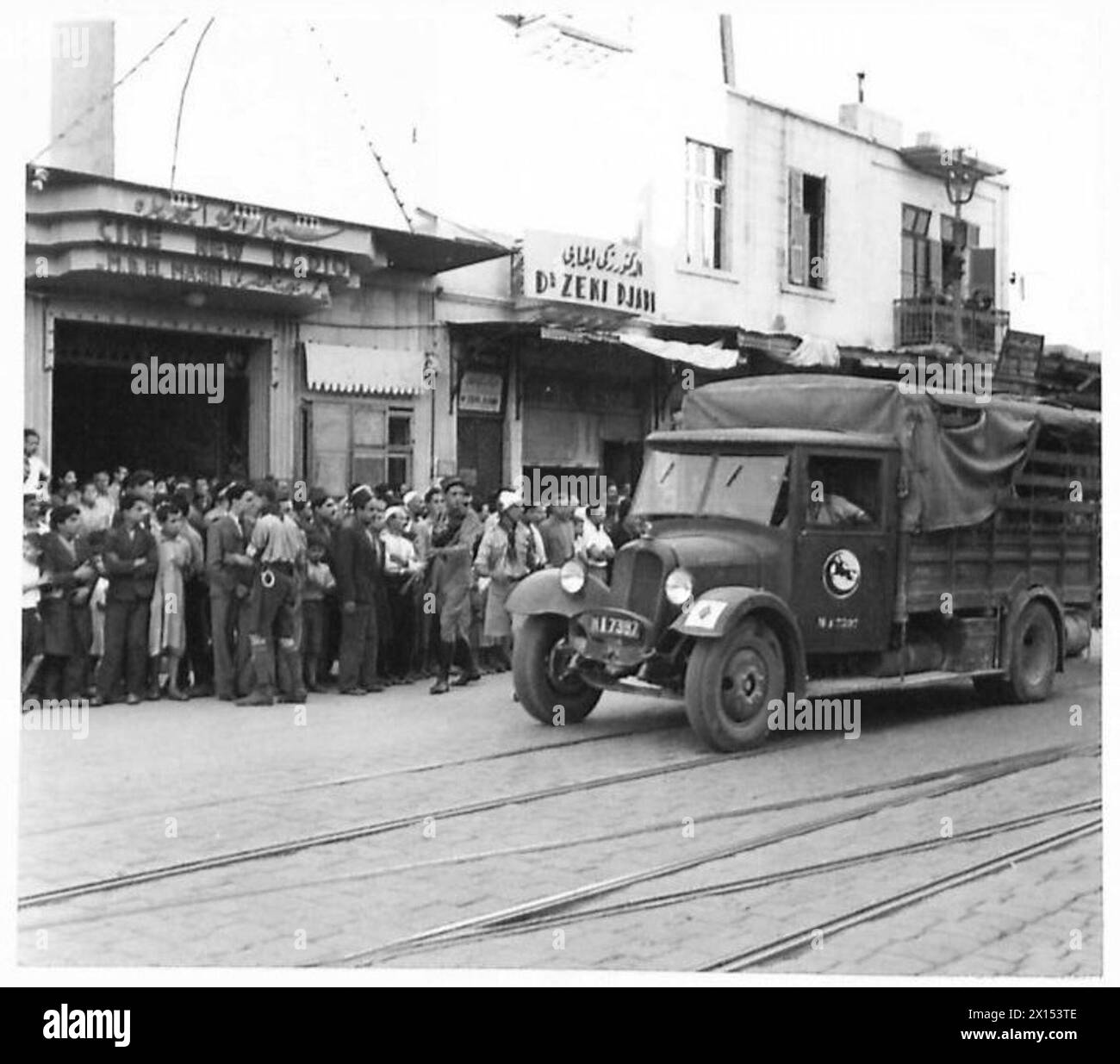 Photograph showing Free French and British transport vehicles driving ...