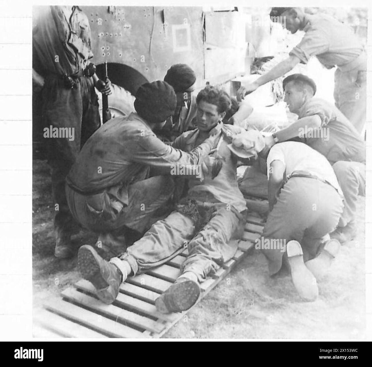OCCUPATION OF FANO - A wounded German prisoner being given attention by ...