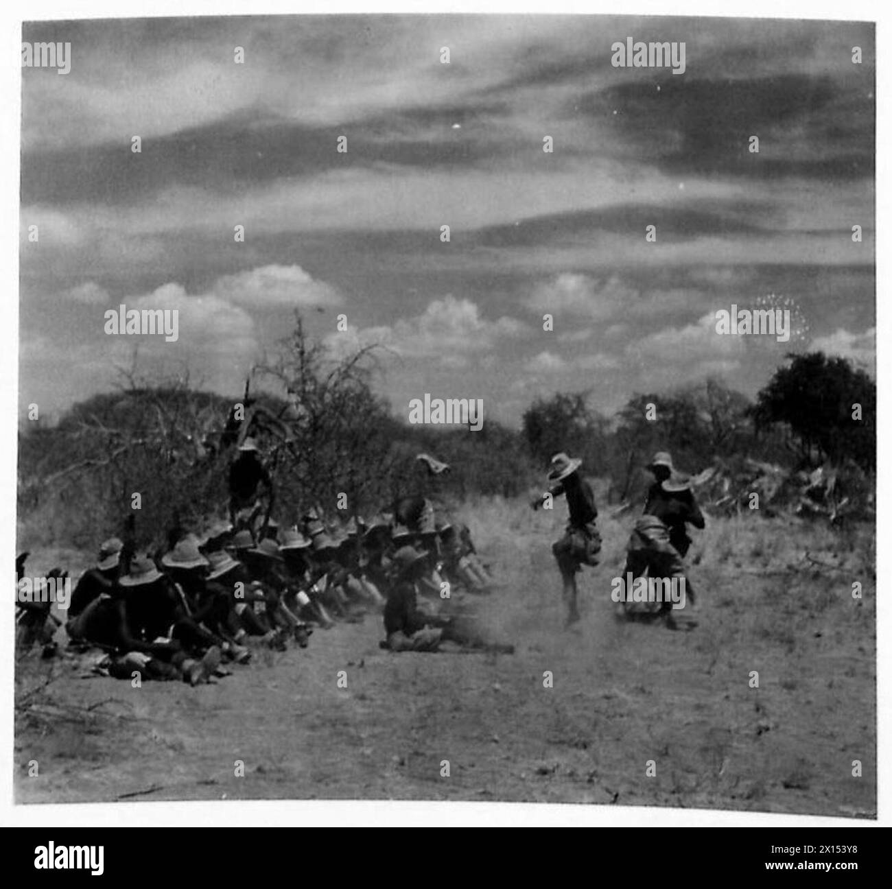 Soldiers of the King's African Rifles rest on the Kenya front, while a ...