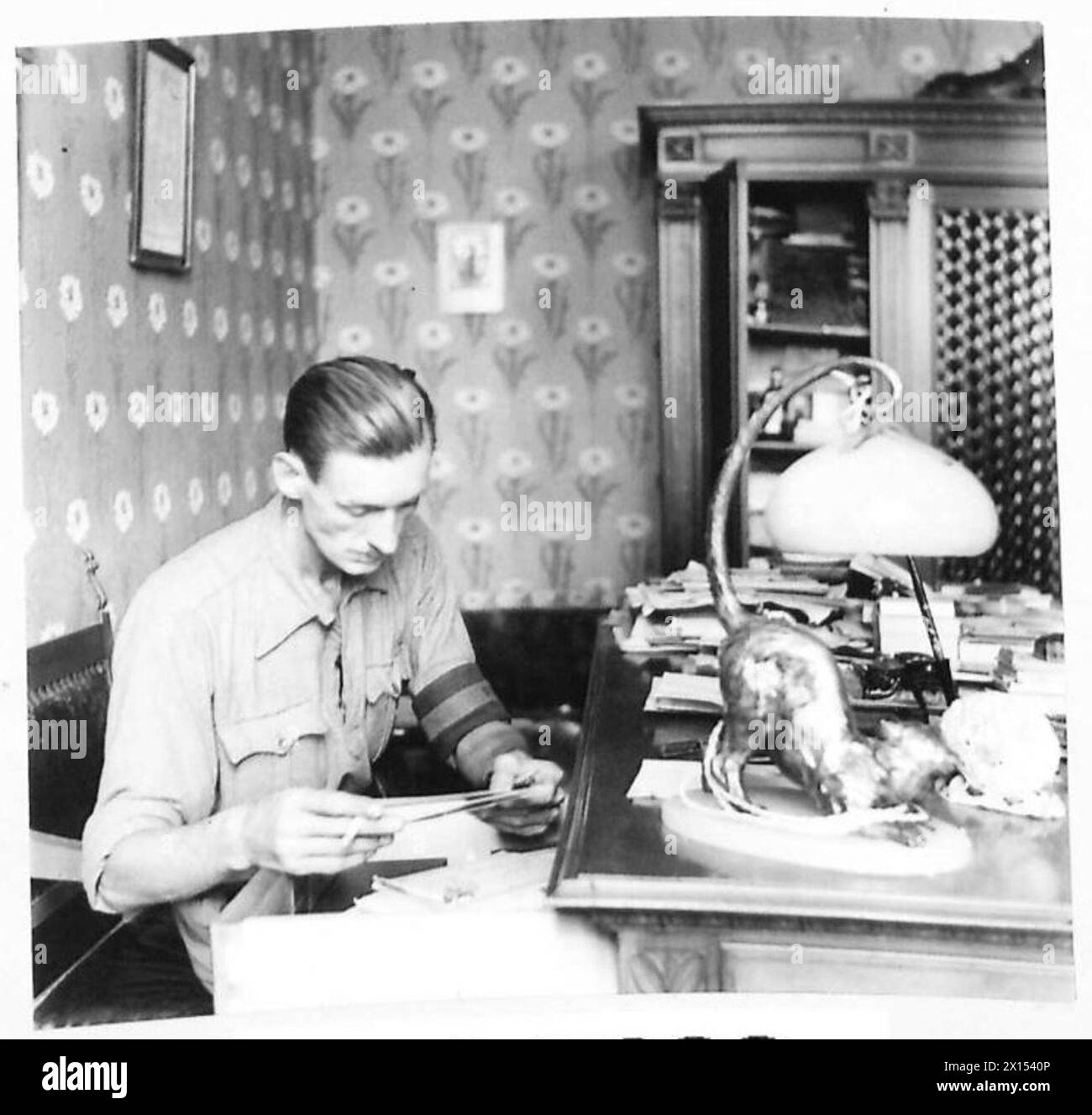 Lance-Corporal L.C. Purse inspects the contents of a desk in a study ...