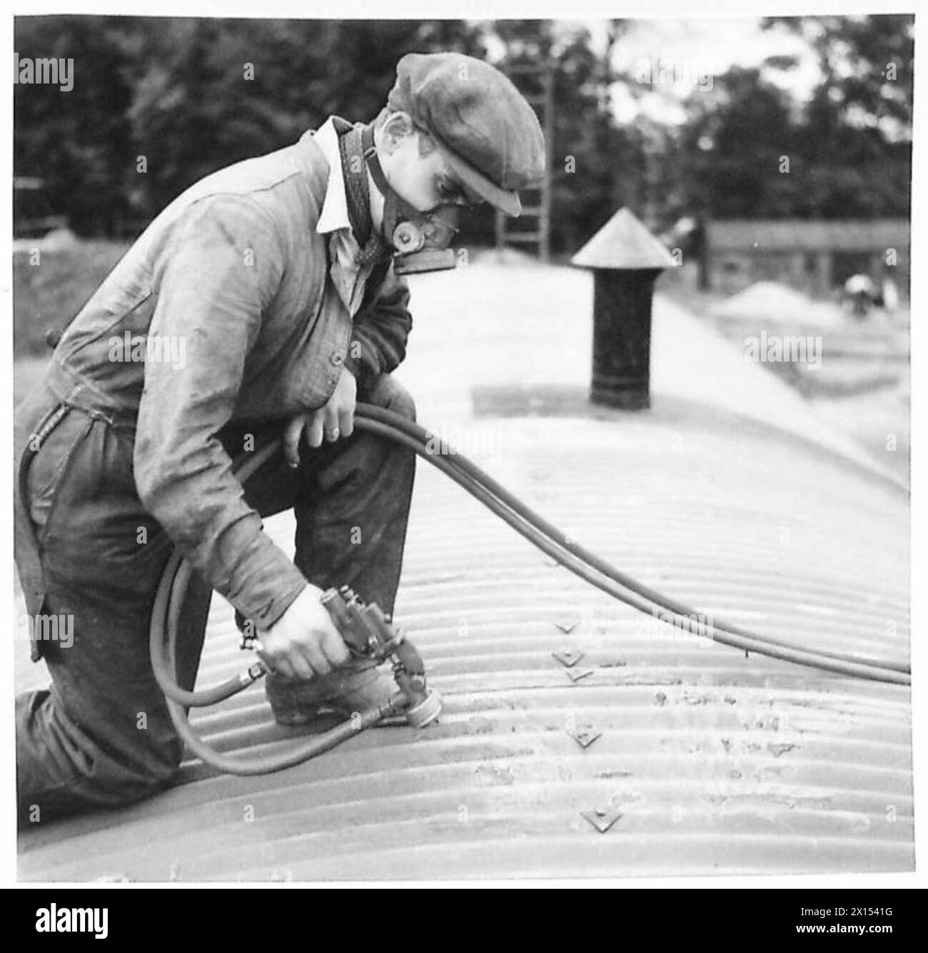 ANOTHER NEW ARMY CAMP - Completion of hut by spraying roof with red ...
