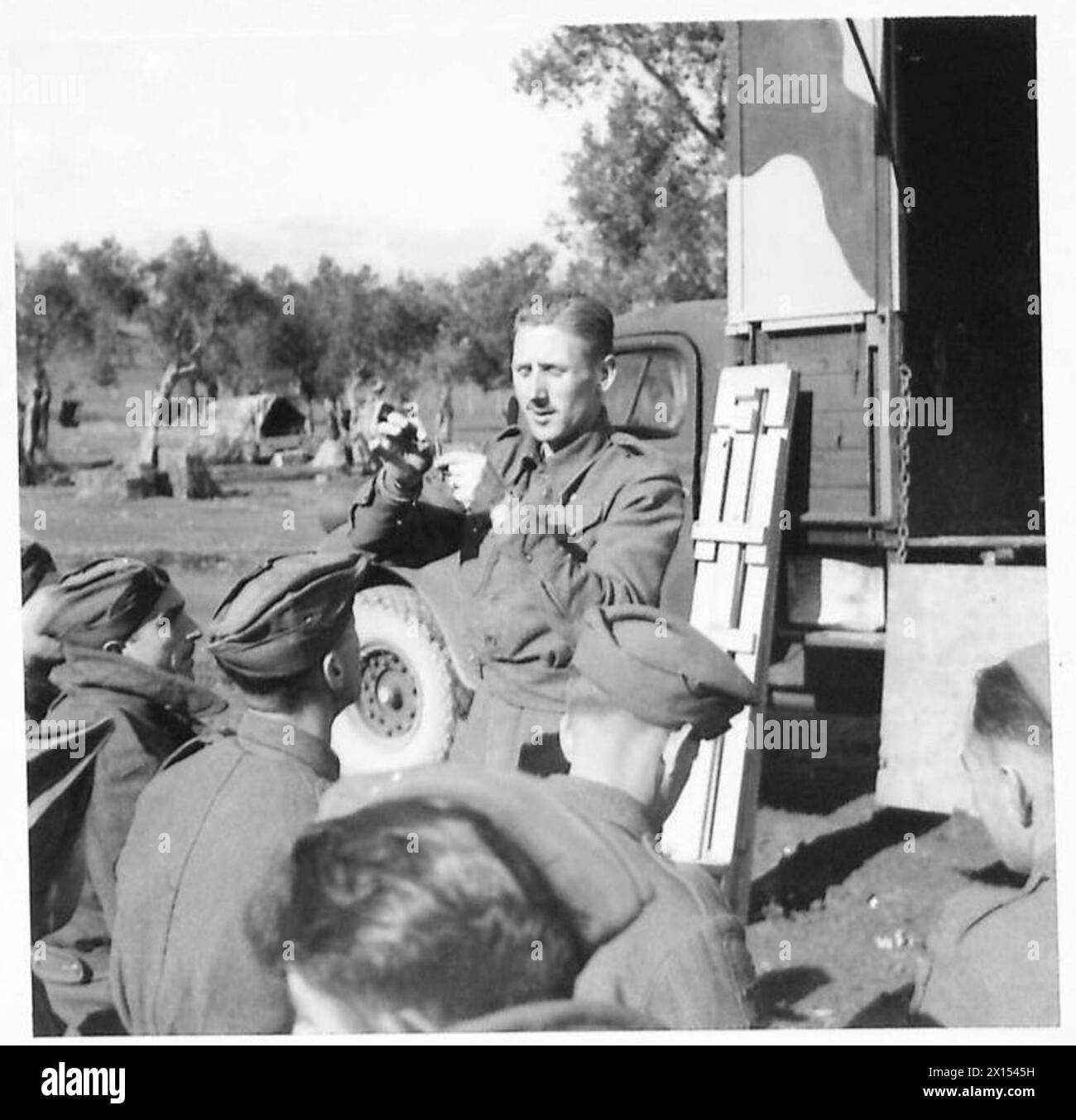 Fifth Army infantry observe a German mine fuse during a training class ...