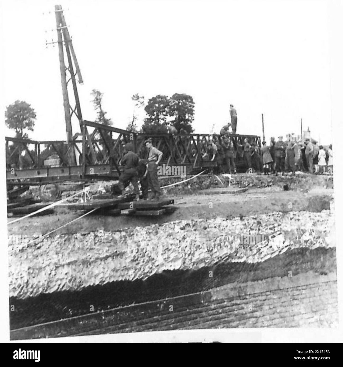 Construction of a Bailey bridge begins in France by British Army ...