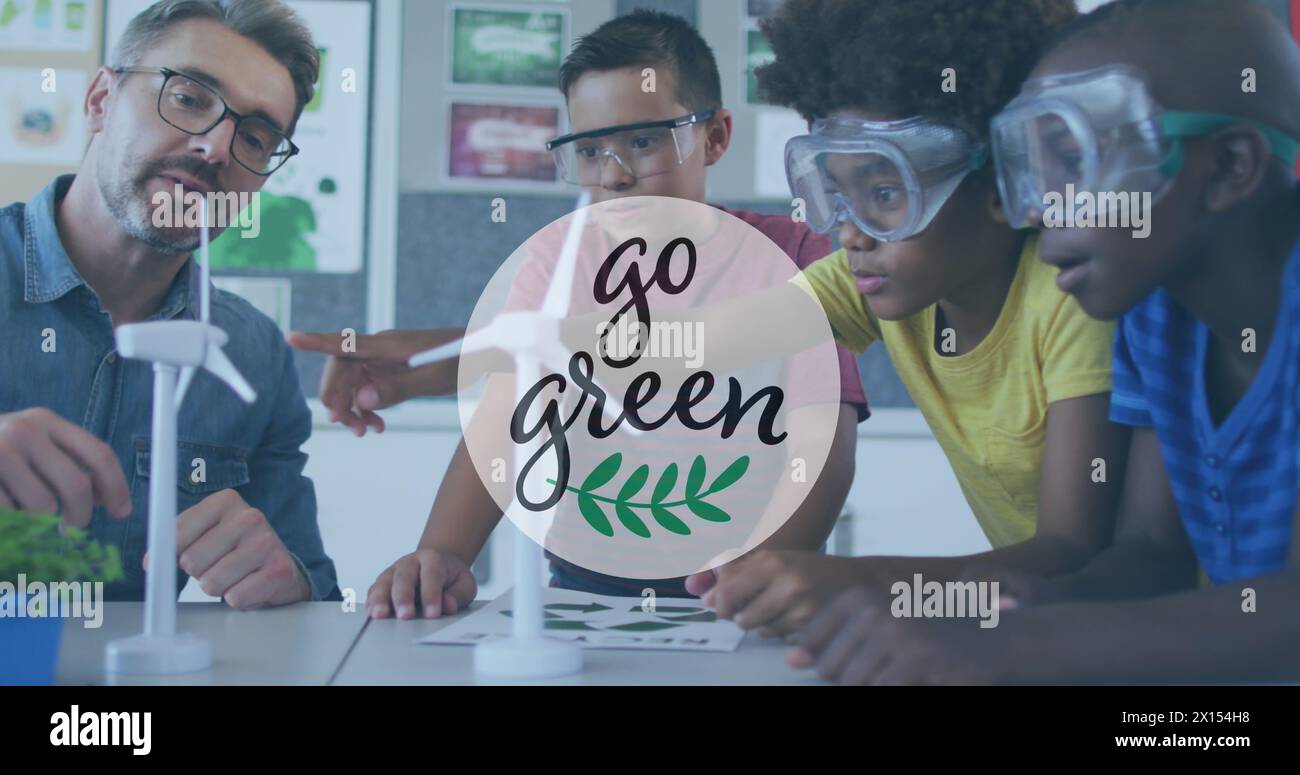 Image of go green text over male teacher and schoolboys looking at wind ...