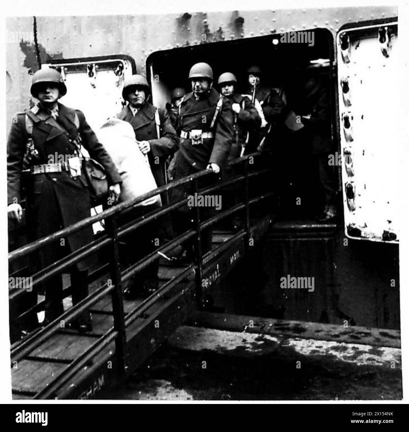 American soldiers arrive and disembark from ships, wearing steel ...