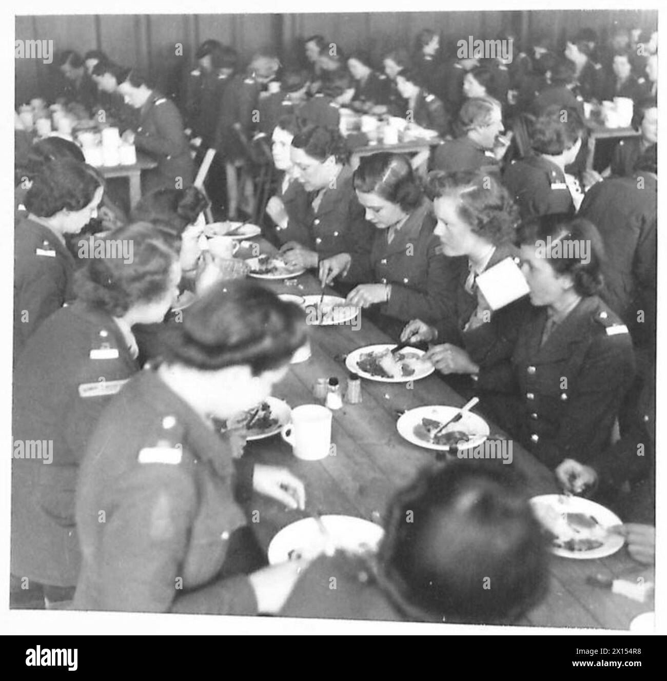 Officer cadets of an ATS training unit have lunch in the dining room ...