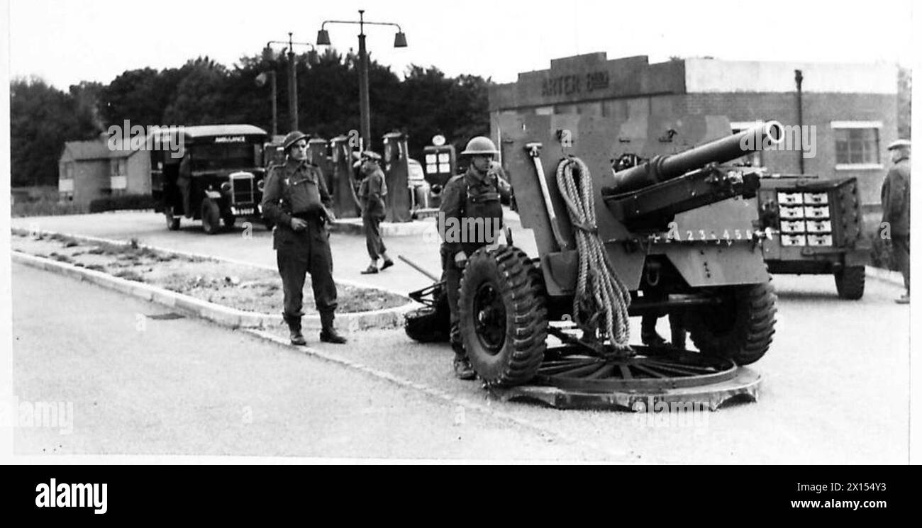 AN EXERCISE IN KENT - A 25-Pounder field gun covering a road British ...