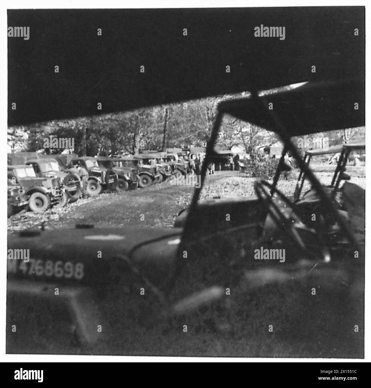Vehicles and military equipment staged in a large park awaiting ...
