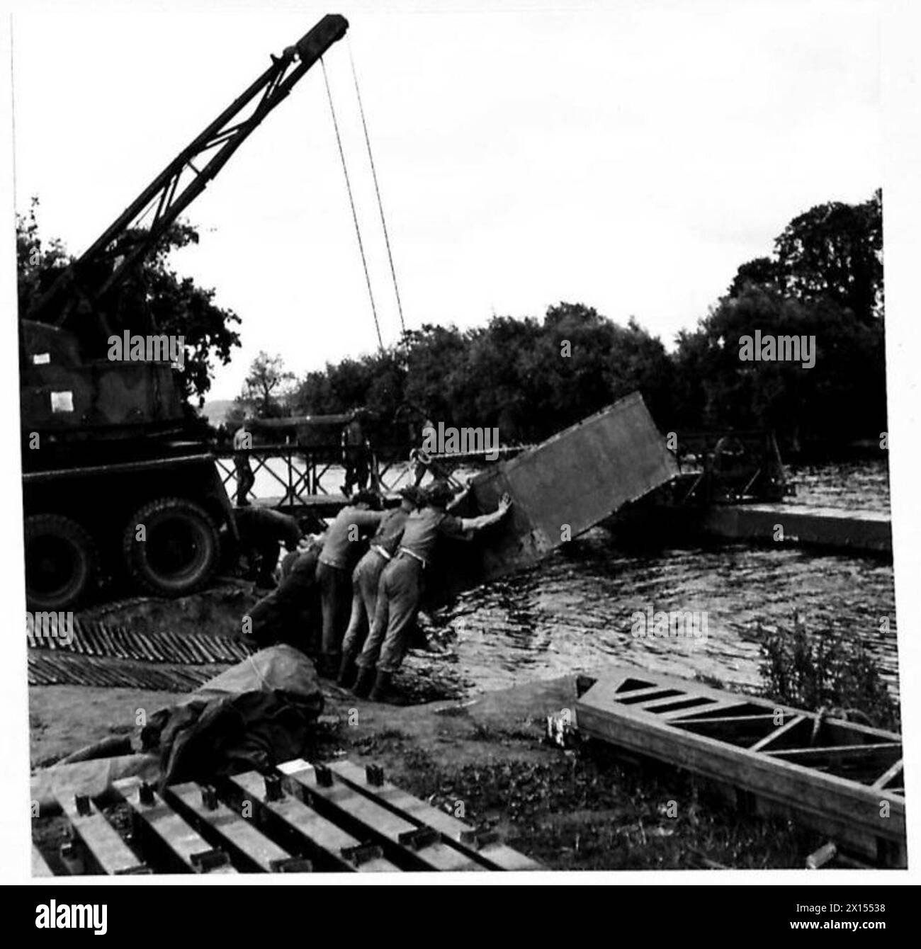 Photographs depict various stages of bridge construction for ...