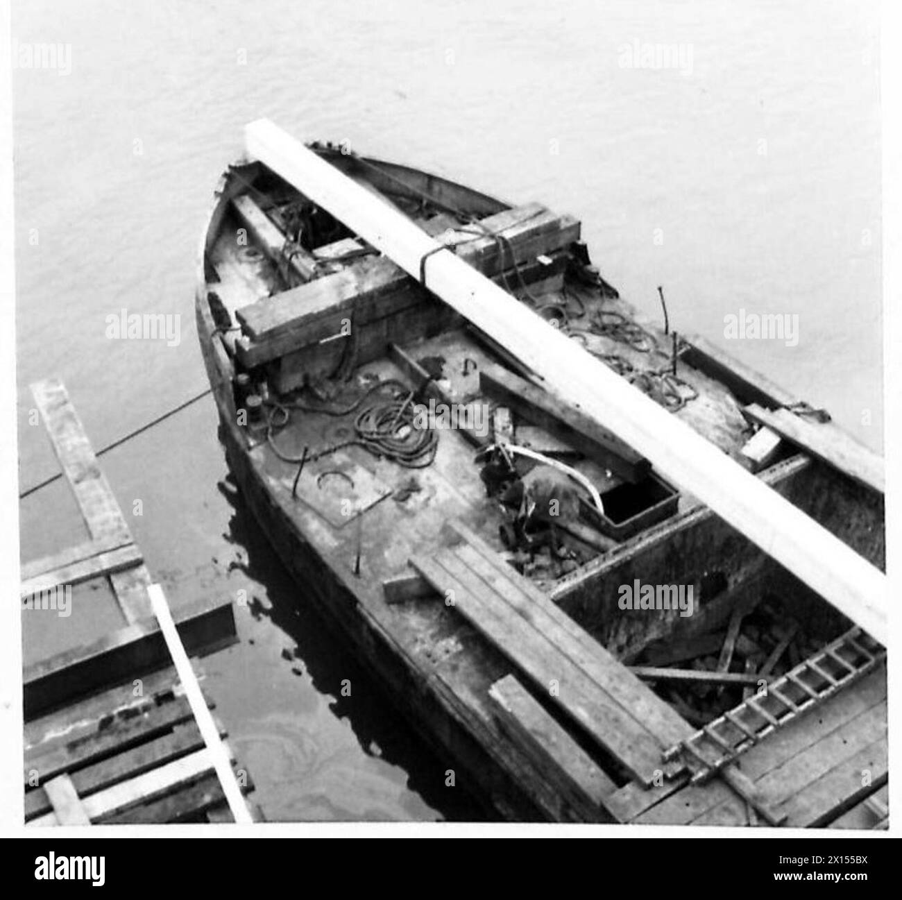 PORT CONSTRUCTION - Pile loaded in barge , British Army Stock Photo - Alamy