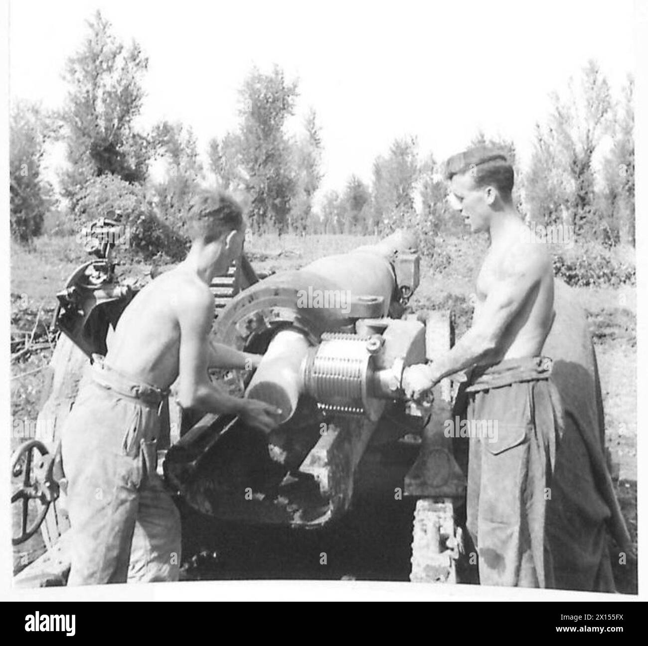 Gun layers operate at the breech of a 7.2-inch howitzer, managing ...