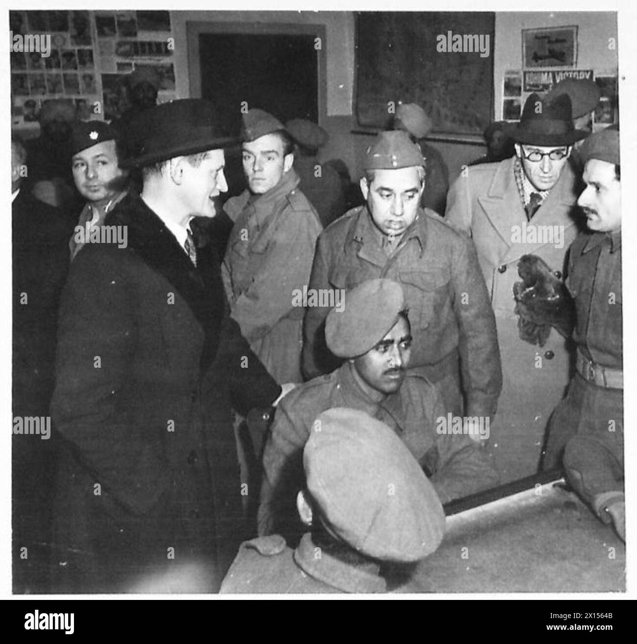Captain Bellenger speaks to Indian personnel in a British Army canteen ...