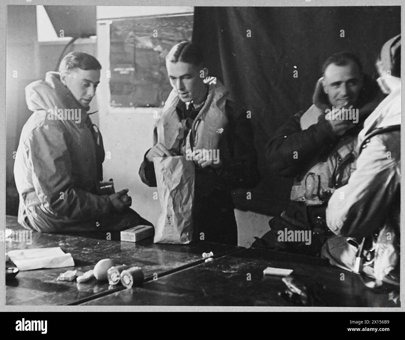 RAF aircrew check final details on bombers before takeoff during a 1942 ...