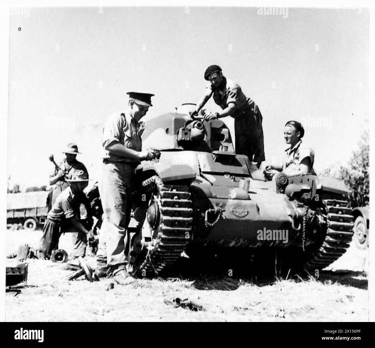 Troops repaint a captured French tank for use by British forces during ...