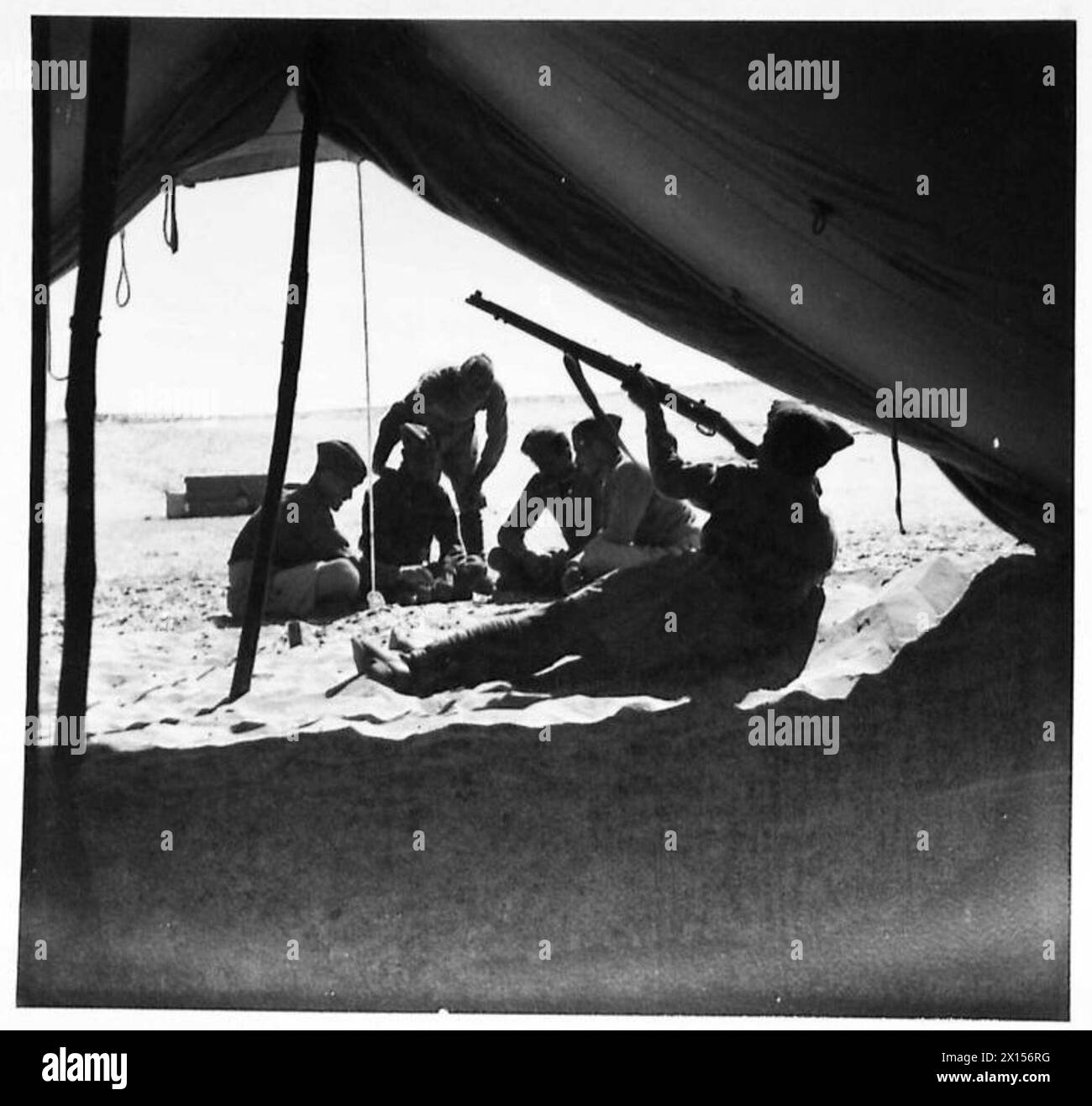 Senoussi Battalion soldiers relax after training, sitting outside their ...