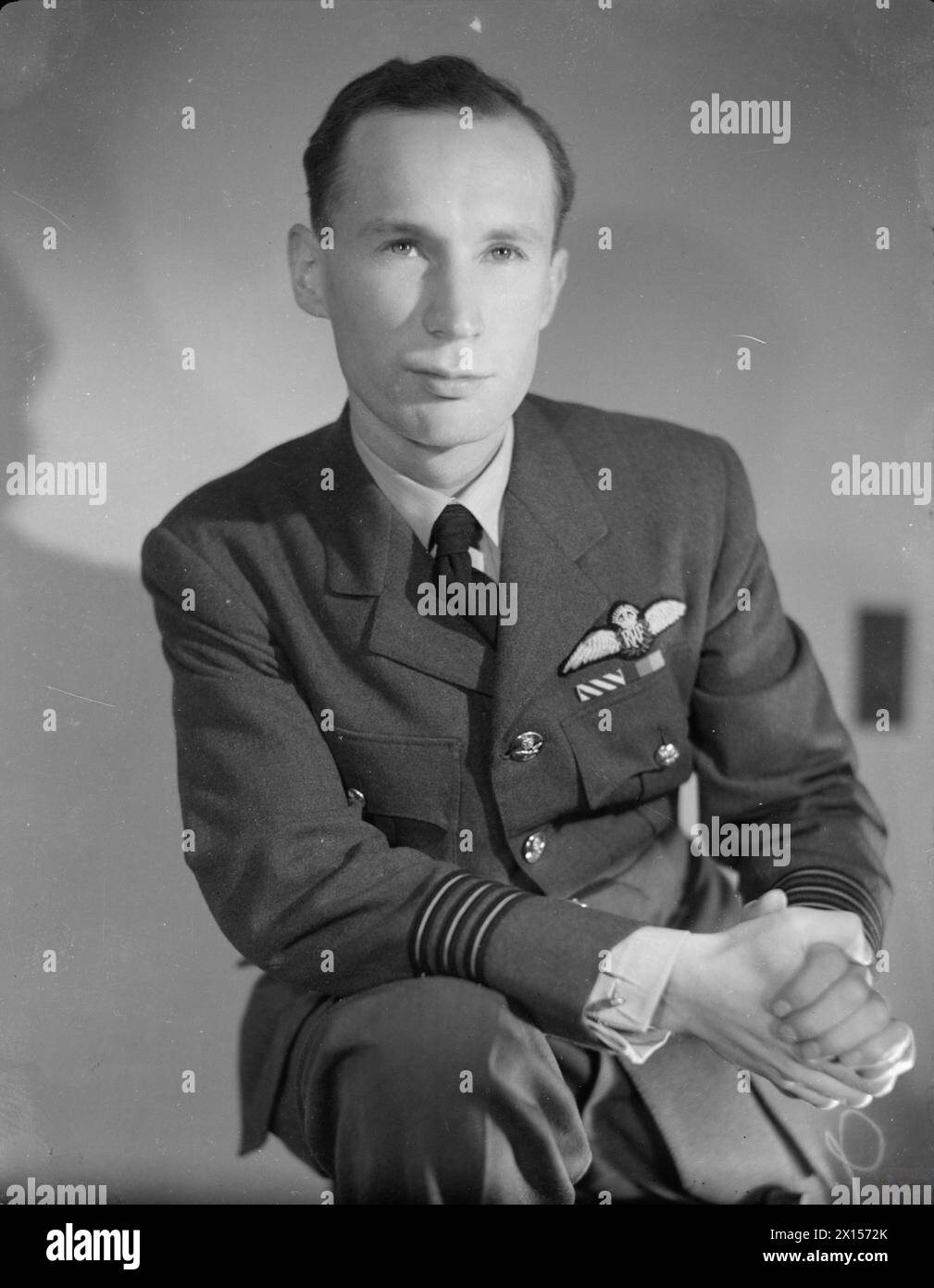 Wing Commander A.M.G. Lywood of No. 228 Squadron RAF is photographed at ...