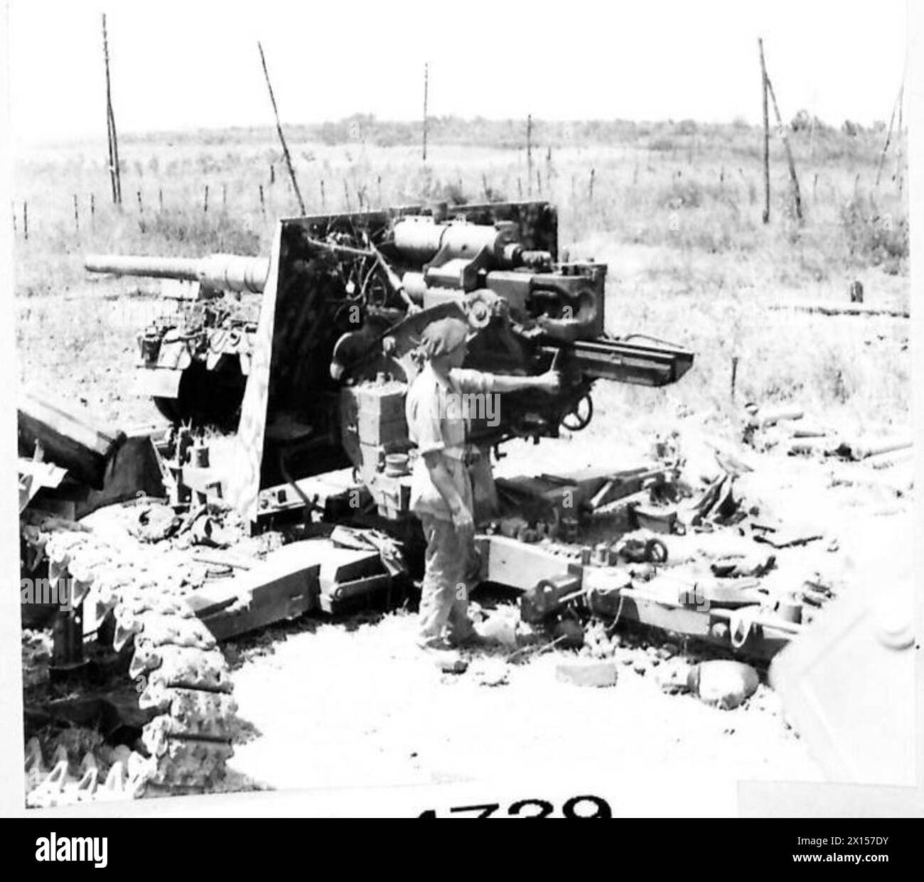 A German 88 mm gun is destroyed during British Army operations in North ...