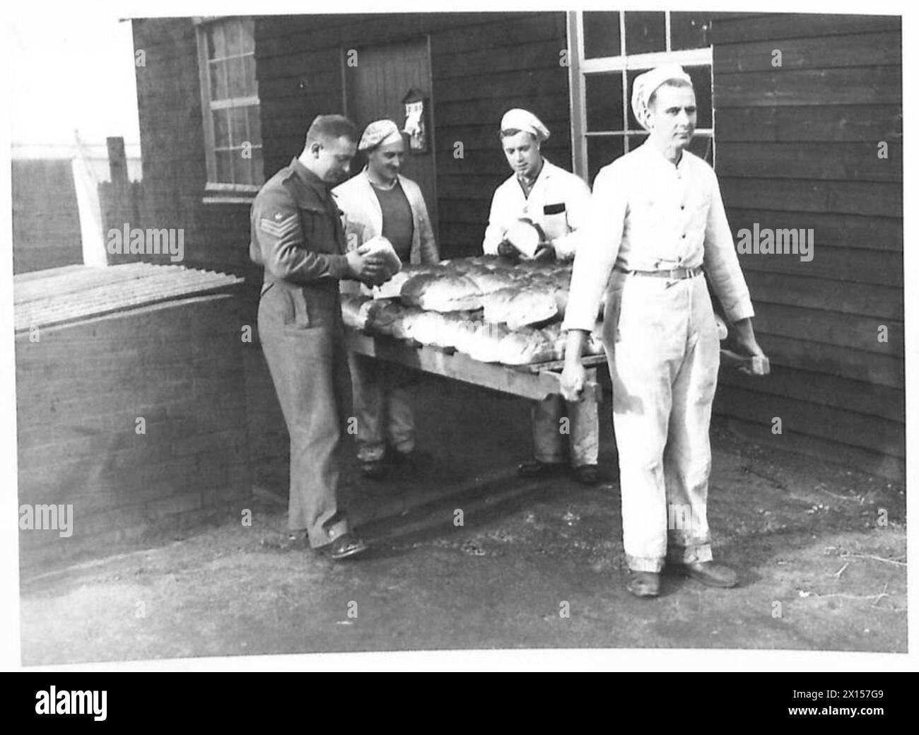 Soldiers work in the Army Bakery at Aldershot, preparing bread and ...