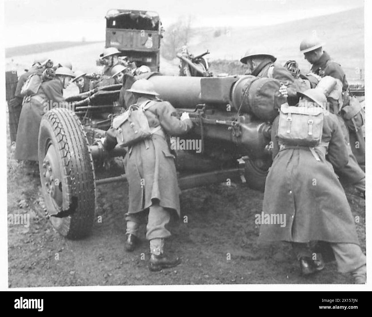 Gunners move a 6-inch Howitzer through a gateway during exercises in ...