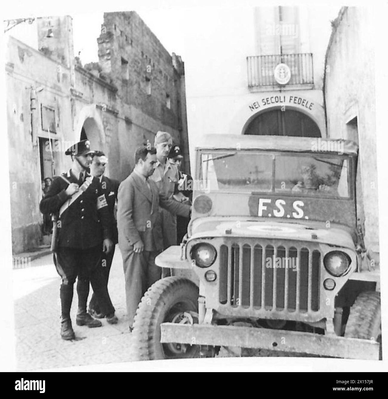Alfonso Fusco, OVRA chief, is escorted aboard a Jeep en route to FSS ...