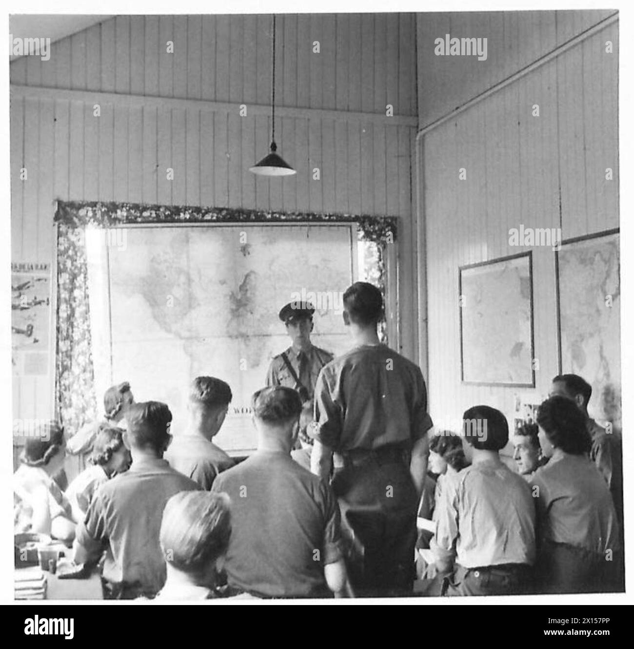 A discussion is taking place at a mixed Anti-Aircraft Battery as part ...