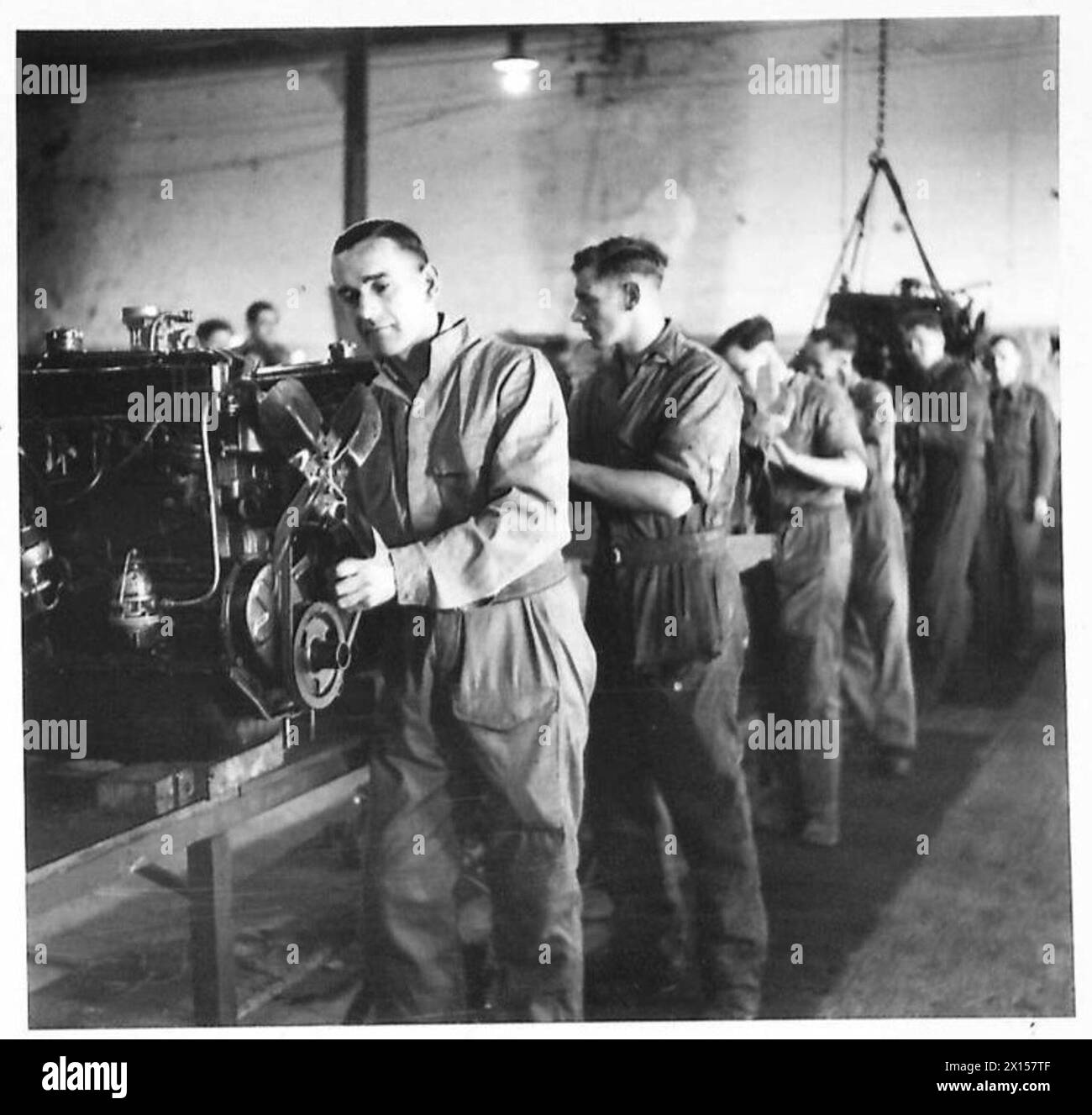 British mechanics work on engines at an advance base workshop motor ...