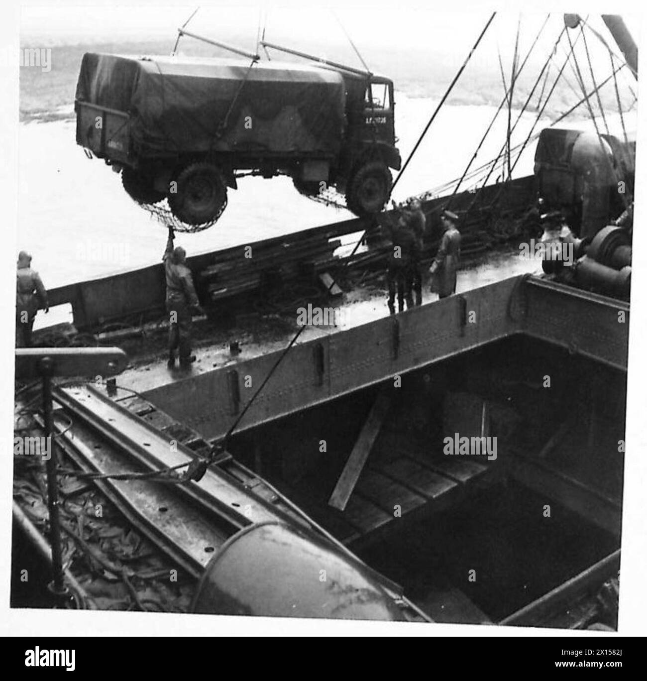 TAKING OFF LORRIES FROM GROUNDED SHIP - Army lorry being hoisted from ...