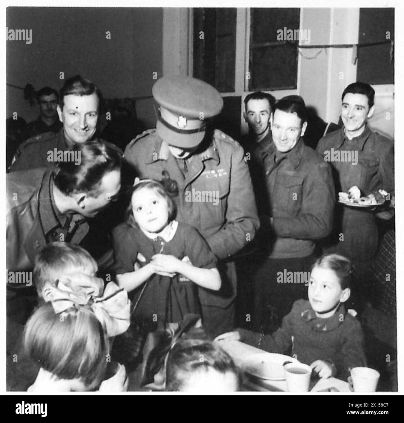 CHILDREN'S PARTY AT 12 CORPS HQ - Brig. Gardham, OBE, with one of the ...