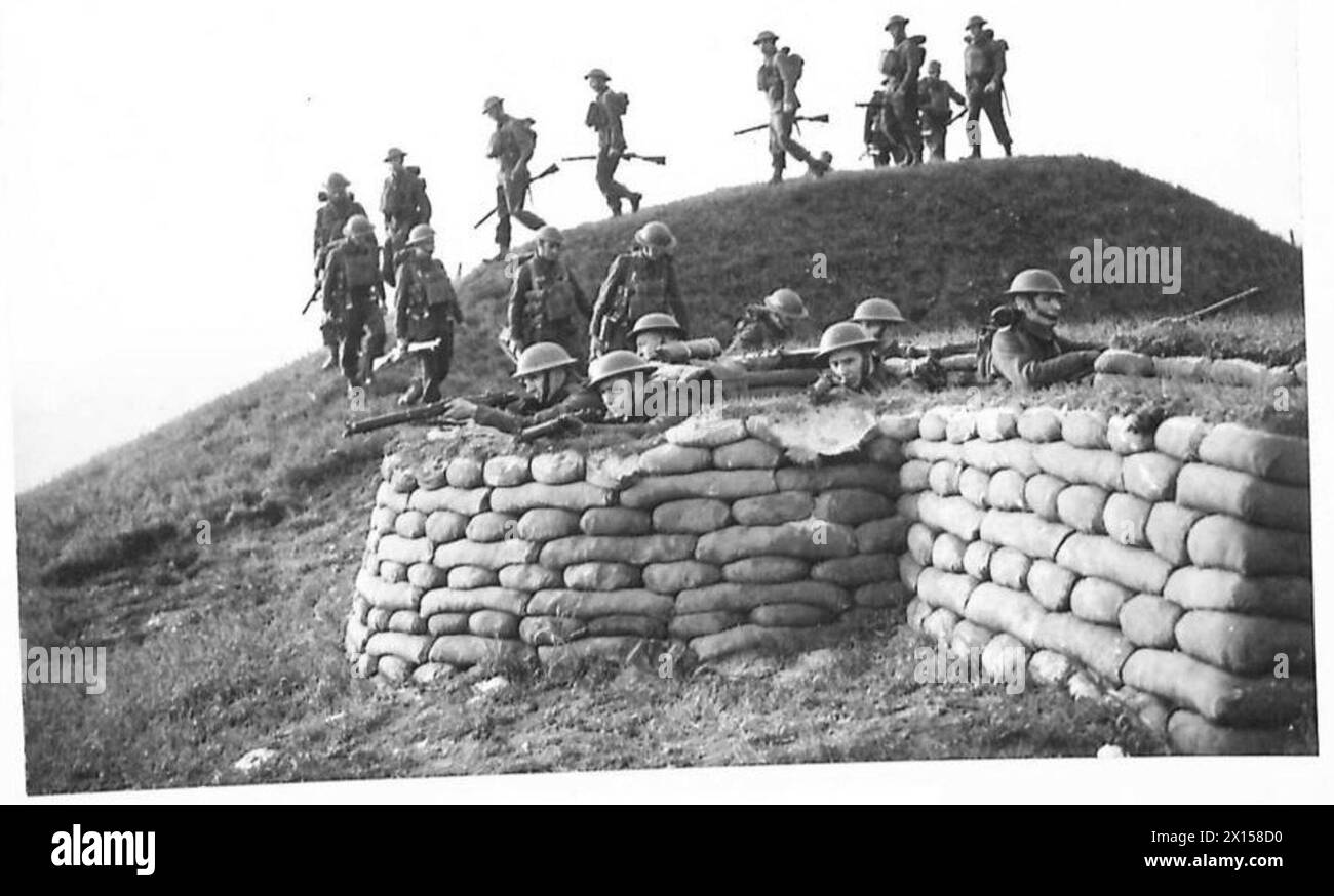 Men take up positions in emplacements on a fort during British Army ...