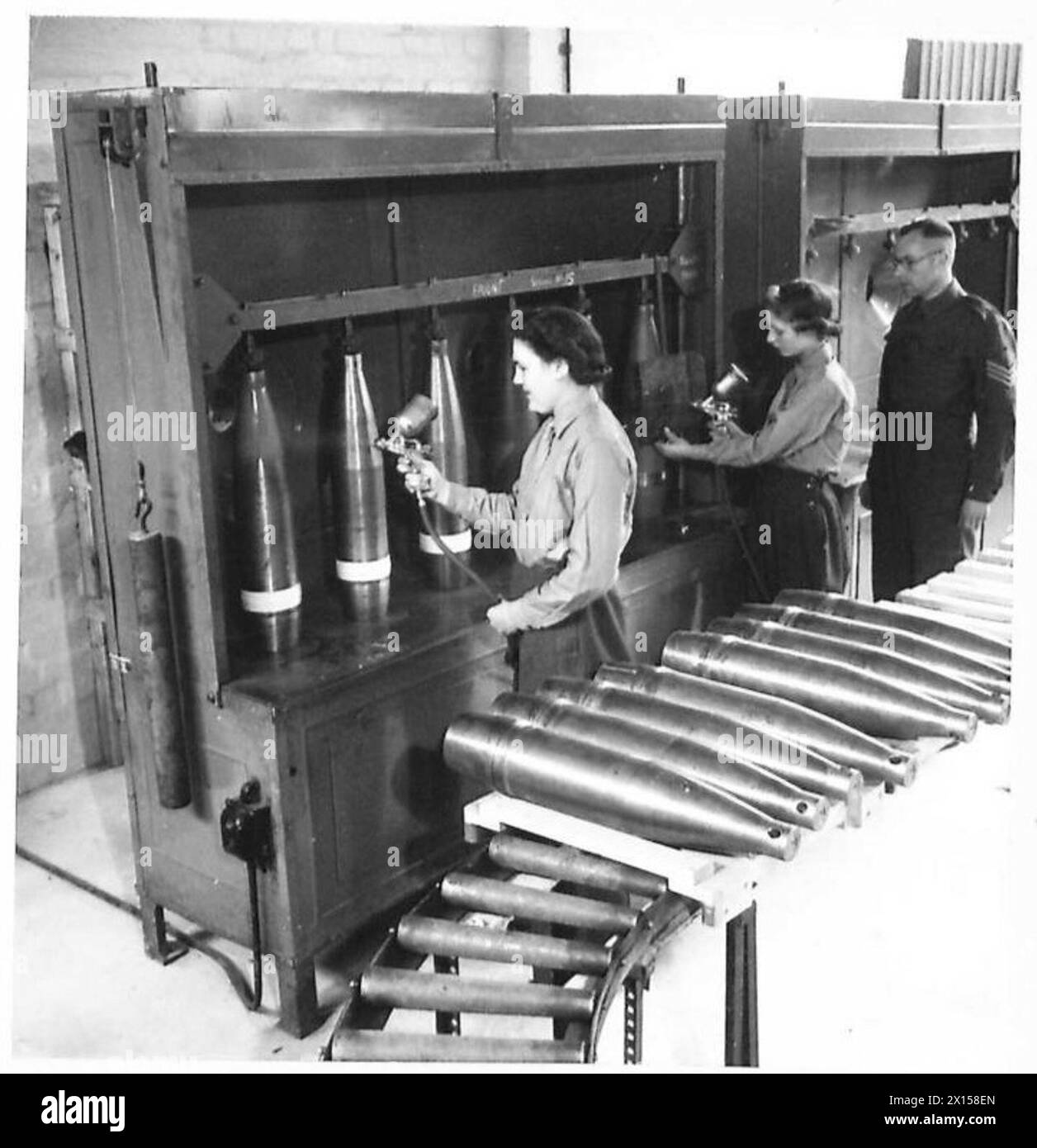 VISIT OF ORDNANCE CHIEFS TO ORDNANCE DEPOT - ATS spraying shells in the ...
