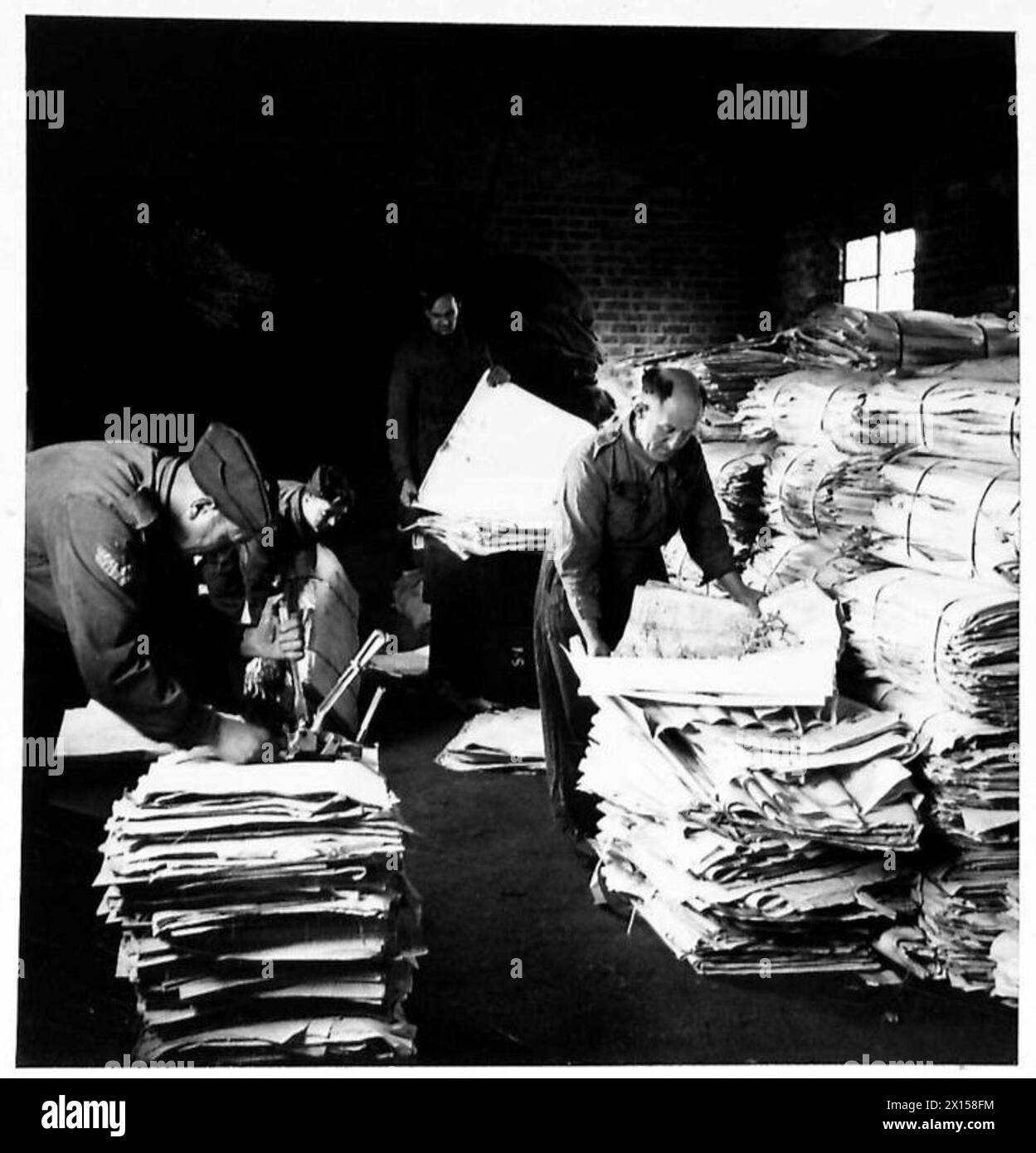 AT A NORTHERN IRELAND ARMY SALVAGE DEPOT - Baling up old Army maps for ...