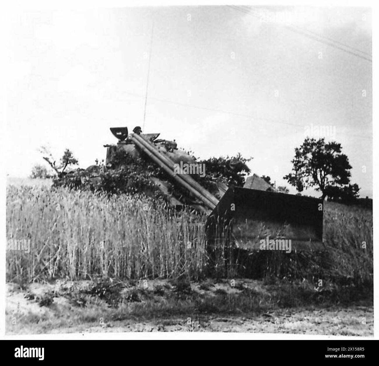 The Sherman bulldozer, an adapted Sherman tank, clears roads in front ...