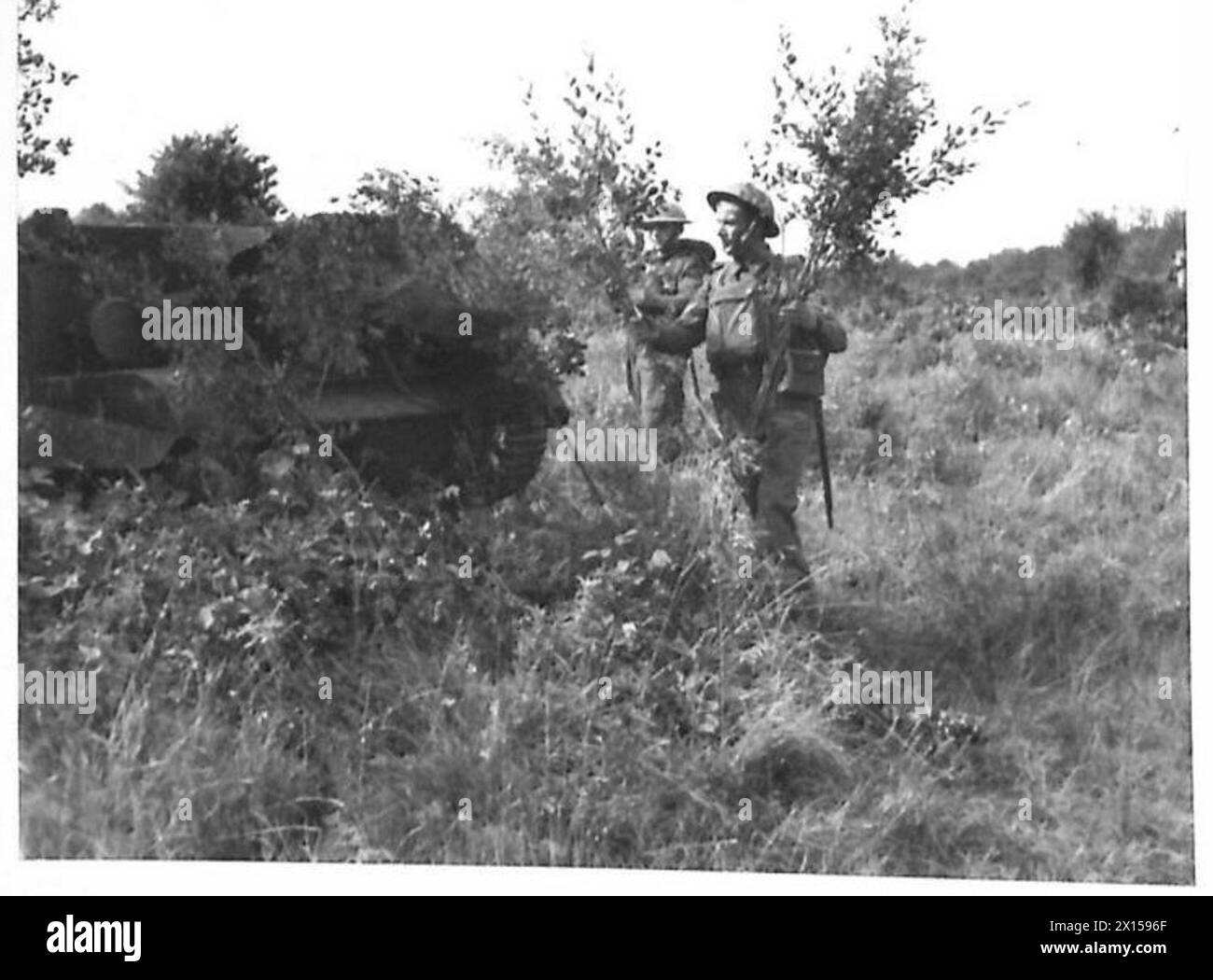 New Recce Corps troops camouflage a Bren carrier using branches during ...