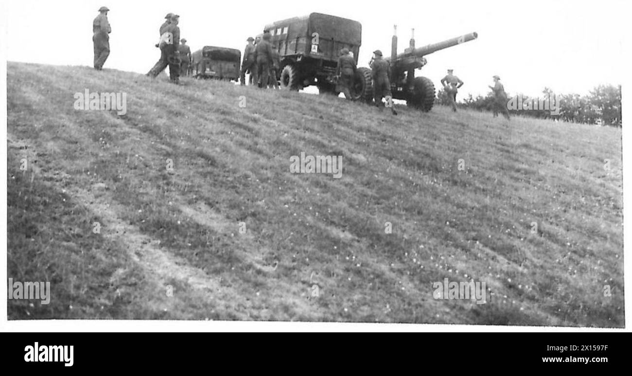 GUN HOWITZERS IN ACTION - One of the guns being hauled up a slope ...