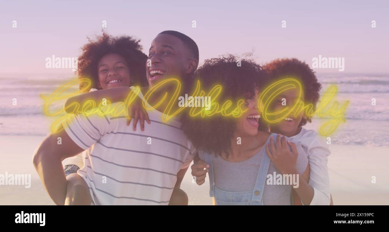 Image of good vibes only over happy african american family having fun ...