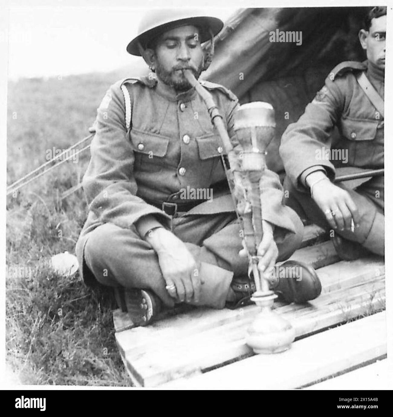 An Indian soldier from the Royal Indian Army Service Corps smokes a ...